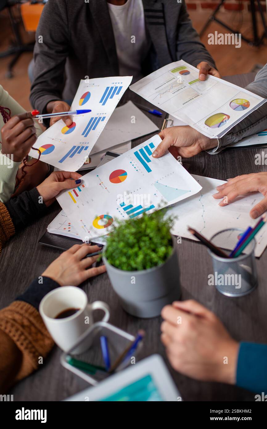 Team collaborating around coffee table hi-res stock photography and ...