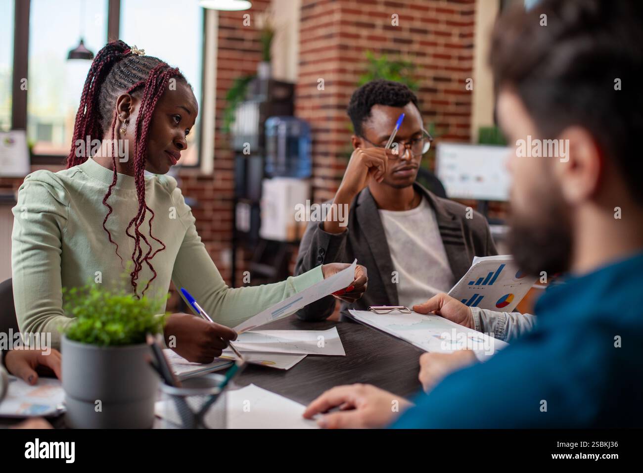 Selective focus on african american businessman and woman reviewing documents during a ...