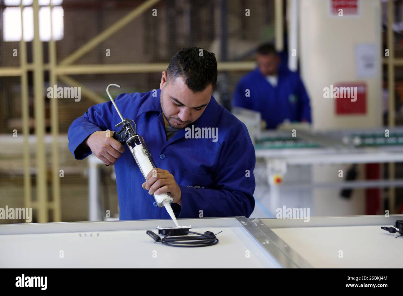 Cairo, Egypt. 1st Feb, 2025. A man works at a solar panel factory in ...