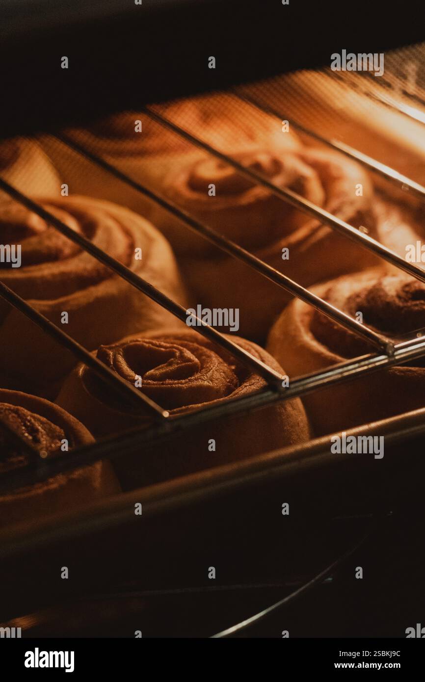 Baking Cinnamon Rolls in Oven Stock Photo - Alamy
