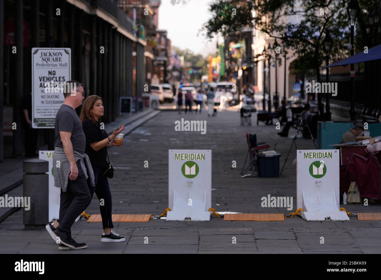 People walk past mobile security barriers next to Jackson Square in the ...