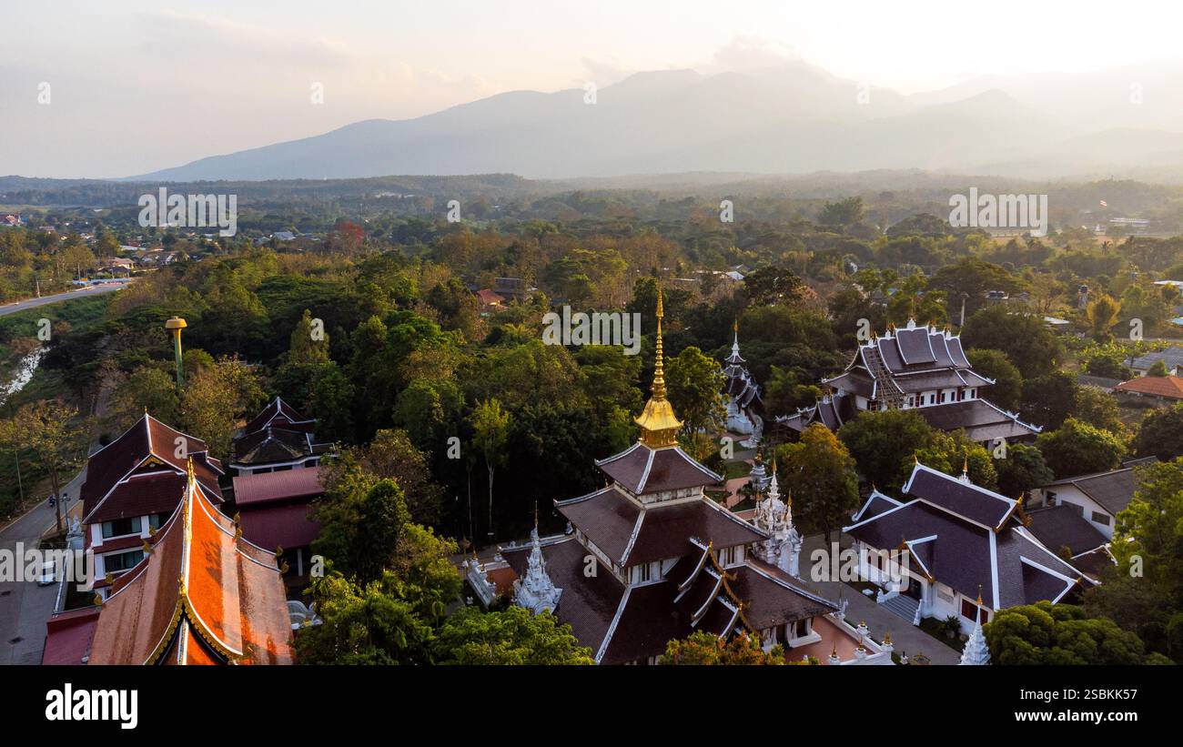 Aerial view of buddhist temples and lush vegetation in Mae Rim district ...