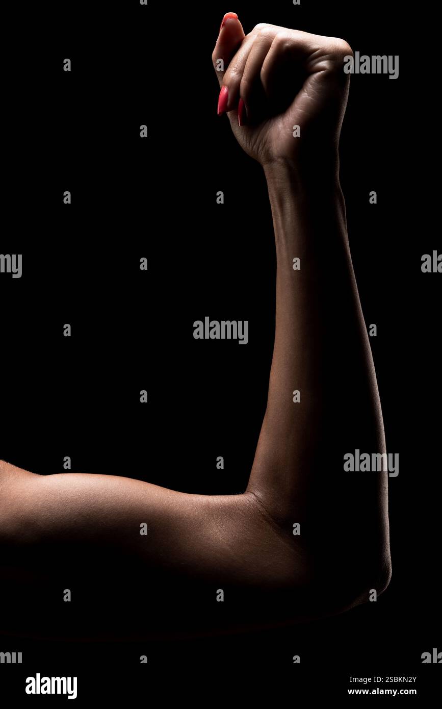 A close-up view of a person's well-defined strong arm with a clenched ...
