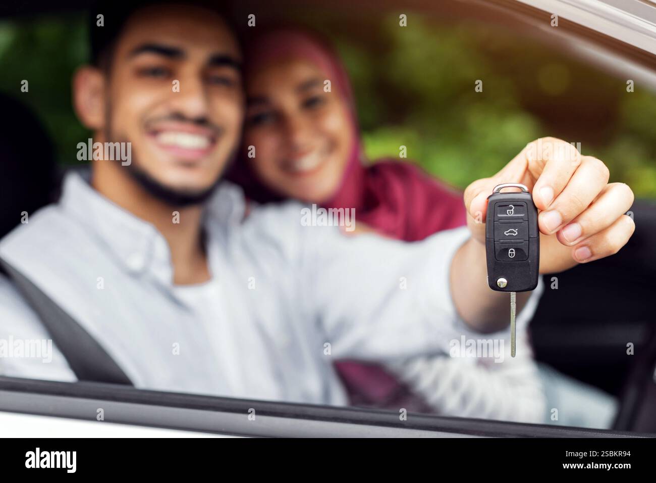 Test drive transport. Glad happy millennial arab woman in hijab and man ...