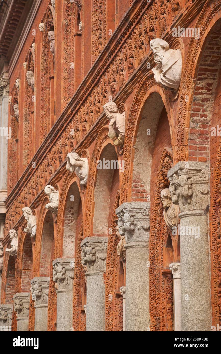 Detail of the ornate red brick exterior of the Ca' Granda old hospital building. Milan, Italy ...
