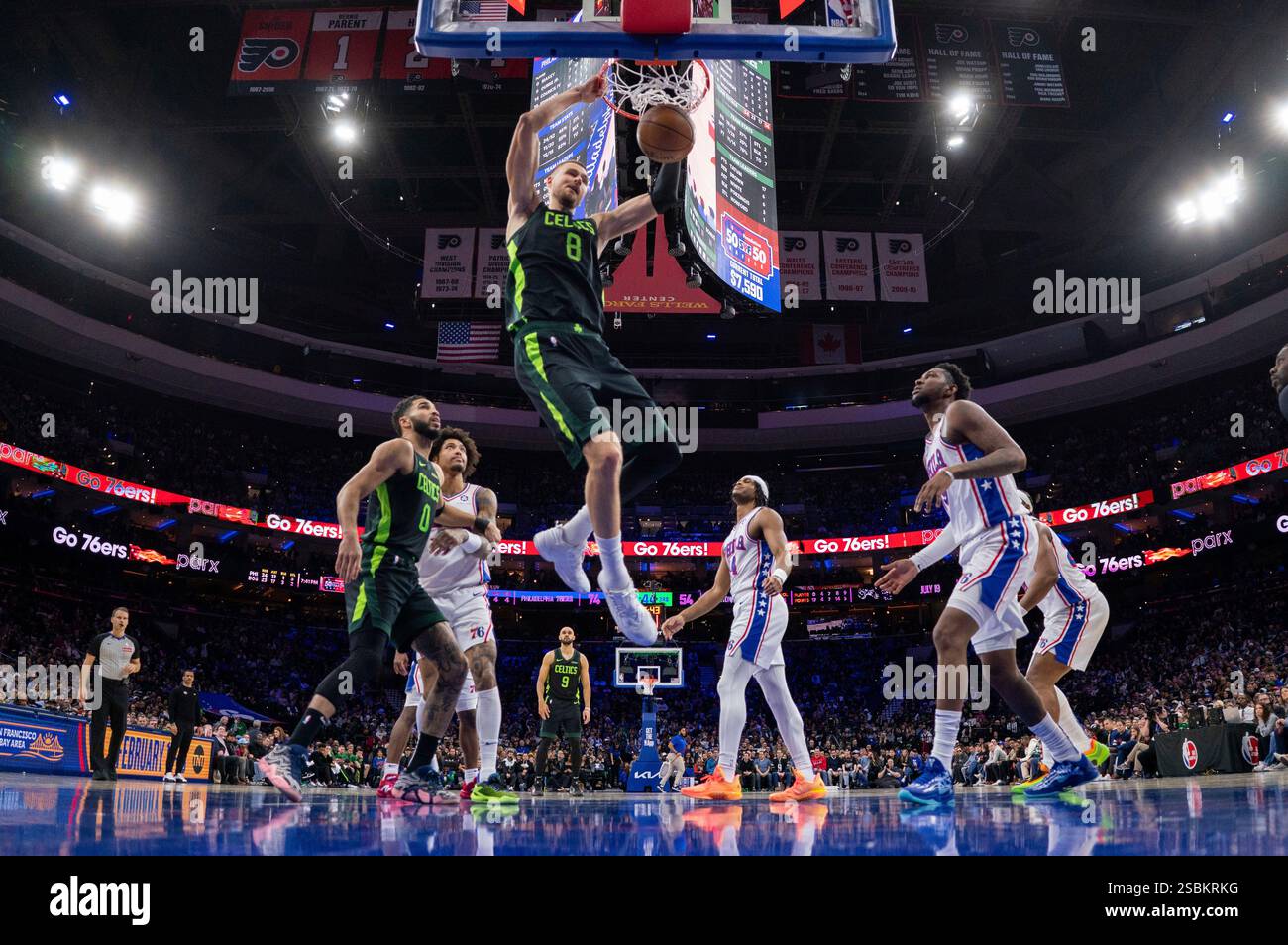 Boston Celtics' Kristaps Porzingis, center, dunks the ball during the ...