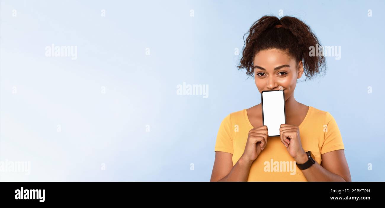 Woman holding cellphone with mockup space next to her face Stock Photo ...