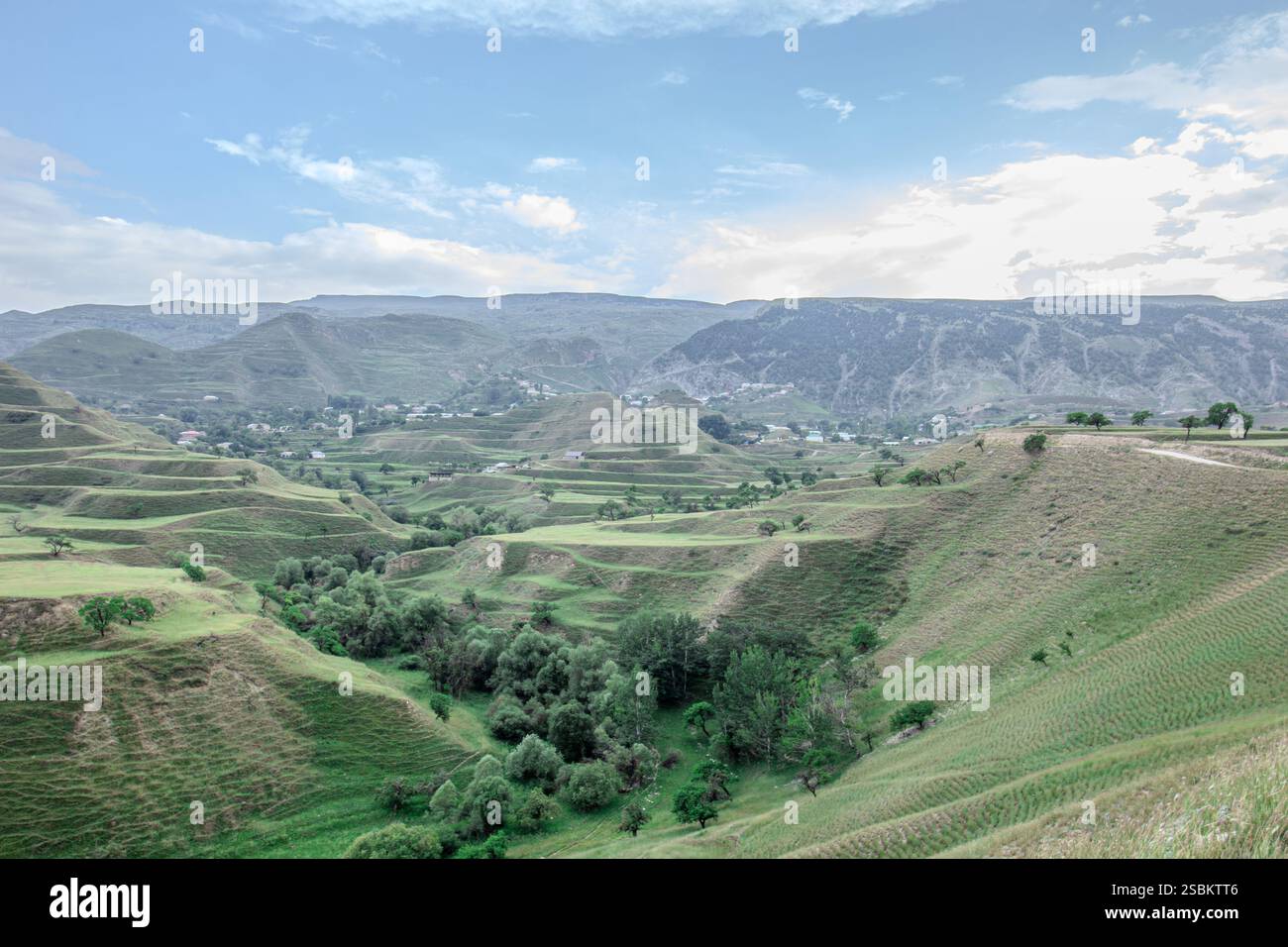 View of green pyramid-shaped layered mountains in the Caucasus plateau ...
