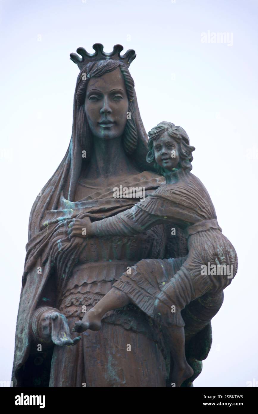 Towering bronze statue of the Virgin and child beside the small Santa ...
