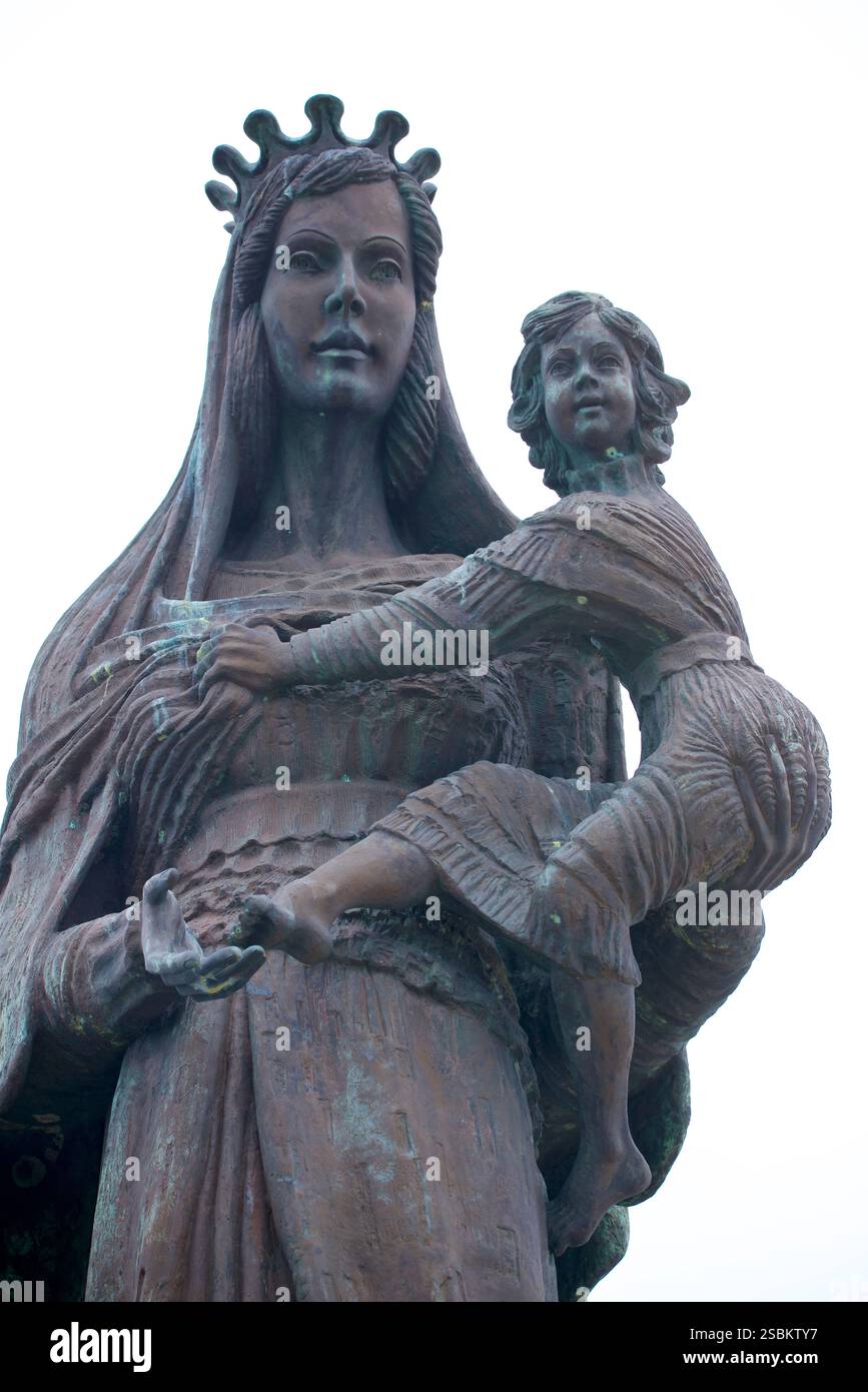 Towering bronze statue of the Virgin and child beside the small Santa ...