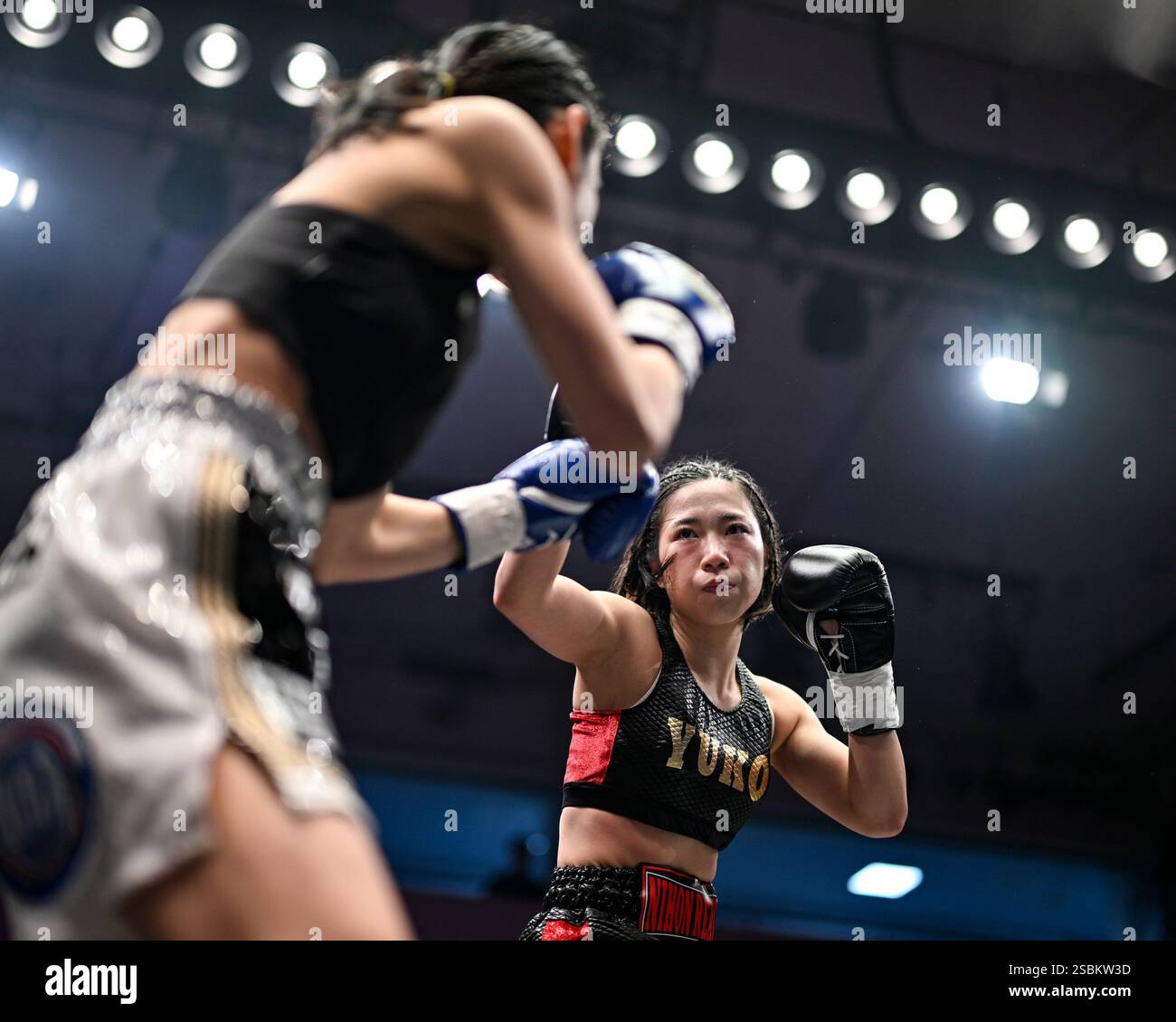 Japan's Yuko Kuroki (black gloves) and South Korea's Seo Ye-Kyeng (blue gloves) compete in the ...