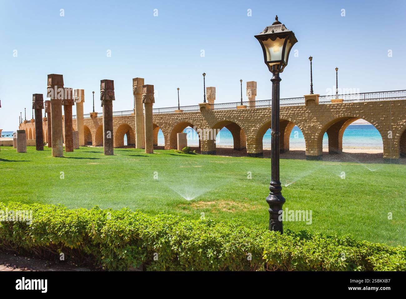 The arched stone colonnade with suspended lanterns Stock Photo - Alamy