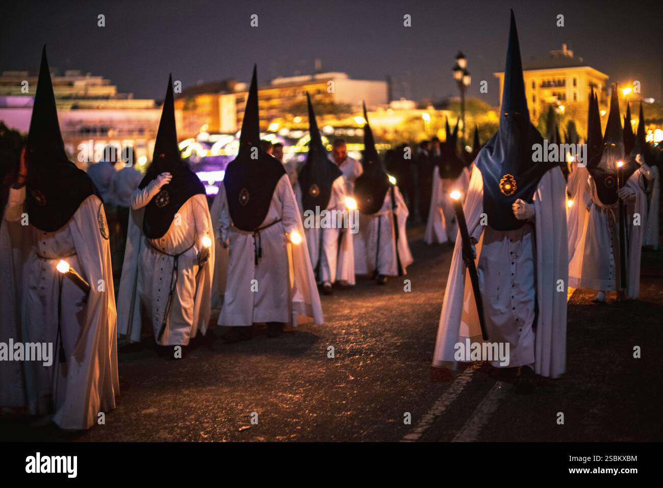 Nazarenos from the Estrella brotherhood walk with candles in the night ...