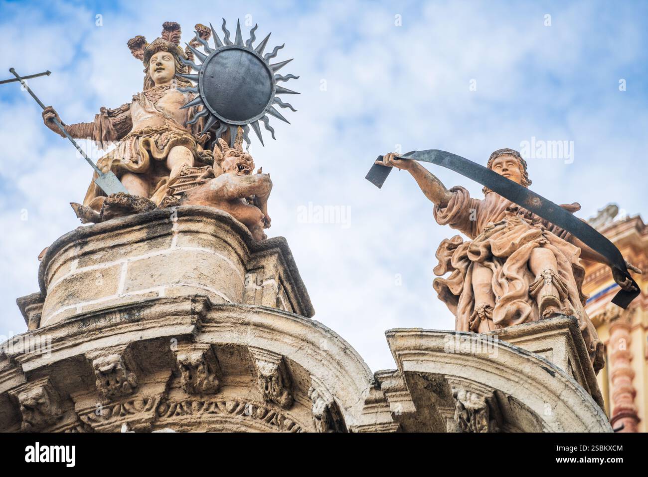 Two ornate statues of archangels crown the baroque facade of San Luis ...