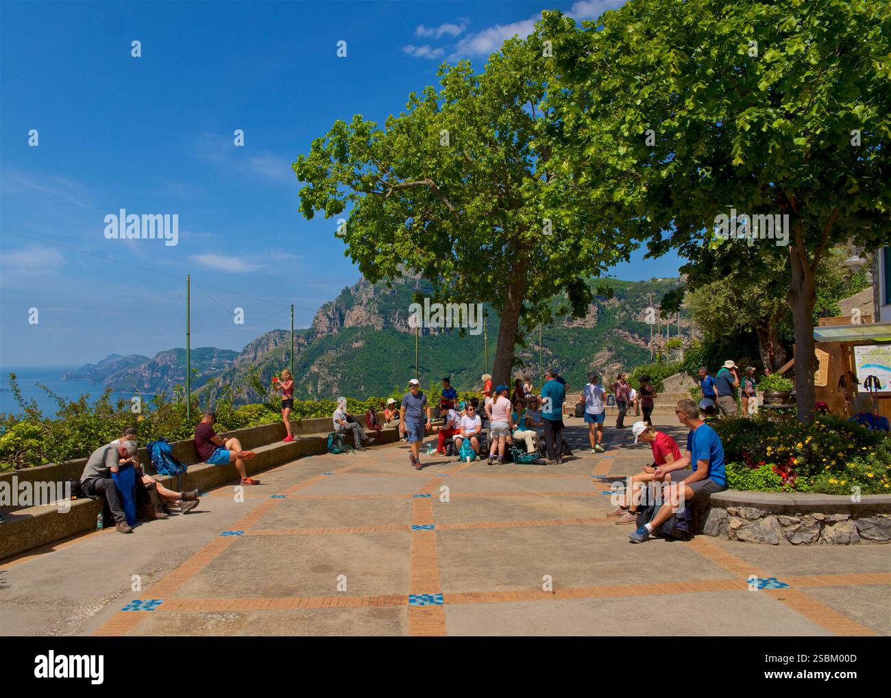 Hikers taking a break in the plaza in front of the Church of the Holy ...