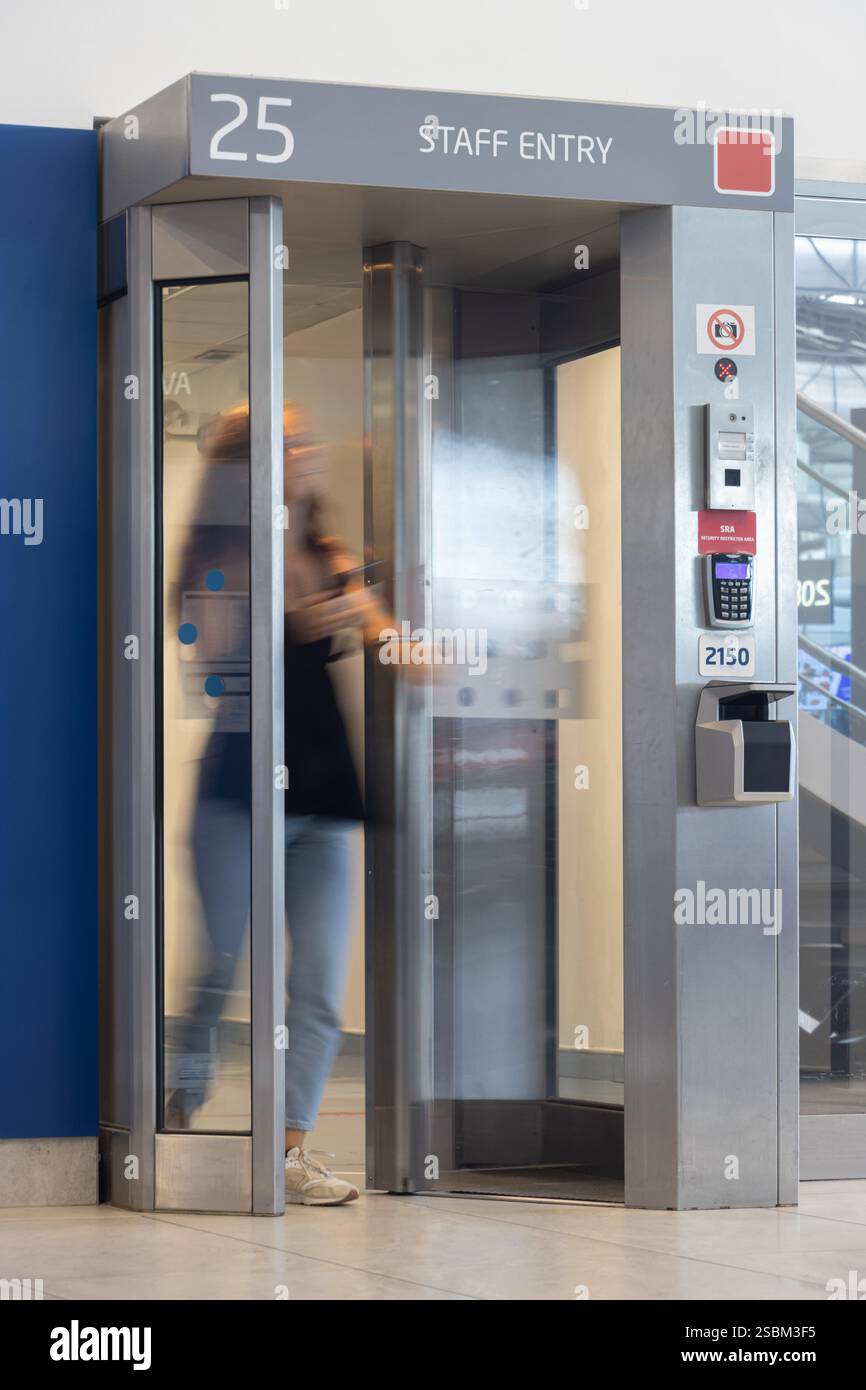 A woman passes through the security entrance for airport personnel ...