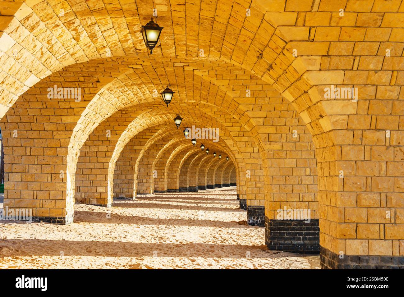 The arched stone colonnade with suspended lanterns Stock Photo - Alamy