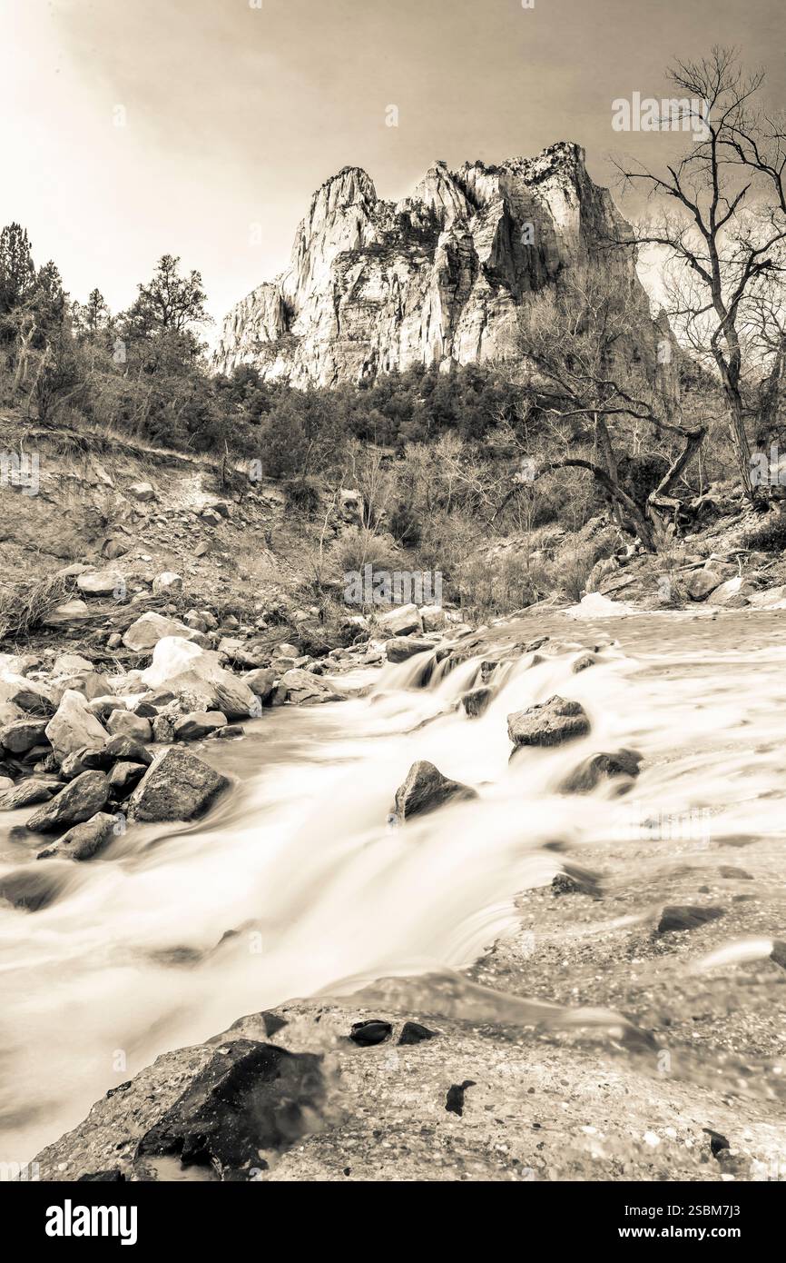 River with a rocky bank. The water is flowing and the rocks are ...