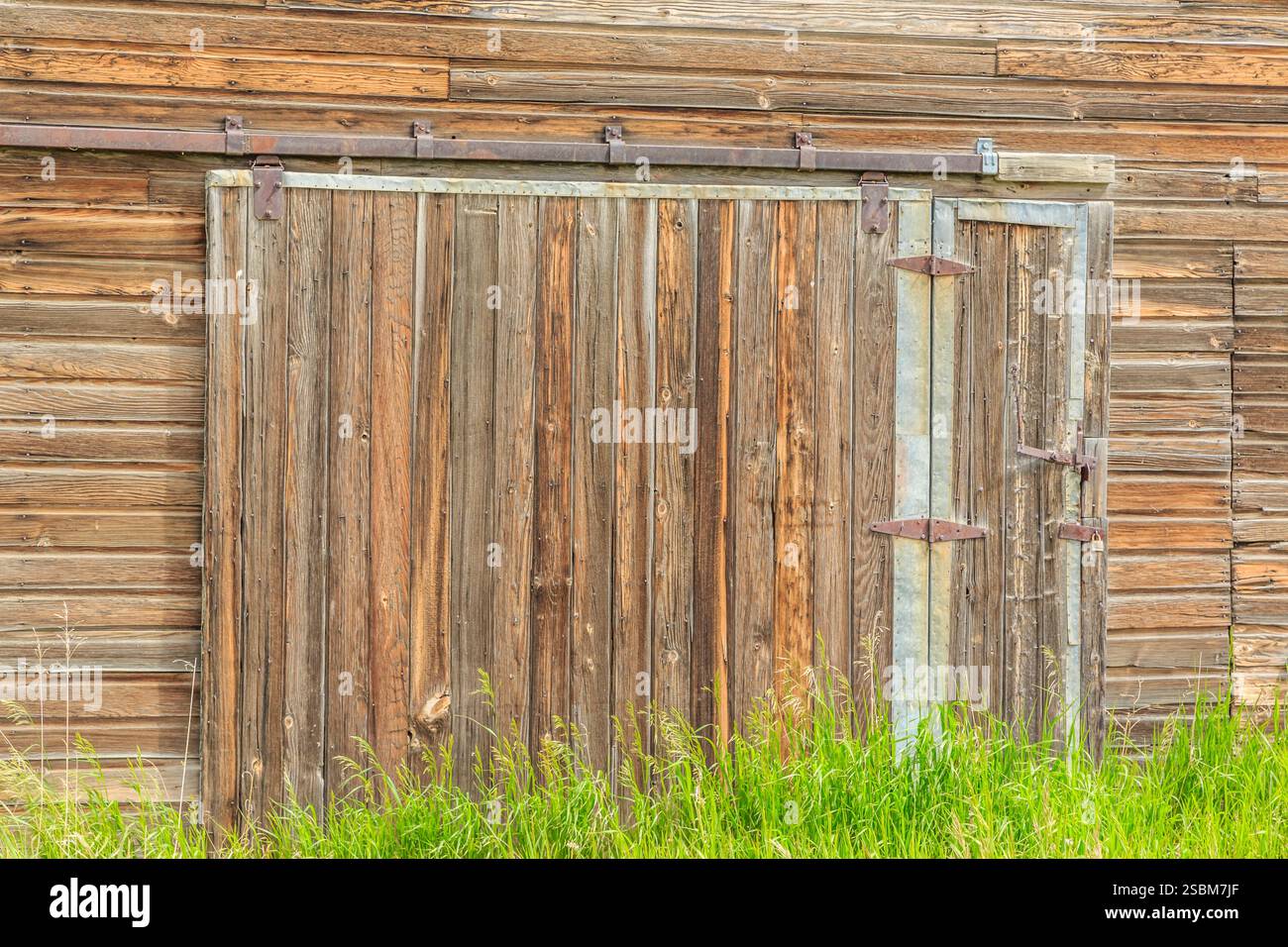 Wooden door with a metal latch. The door is open and the latch is ...
