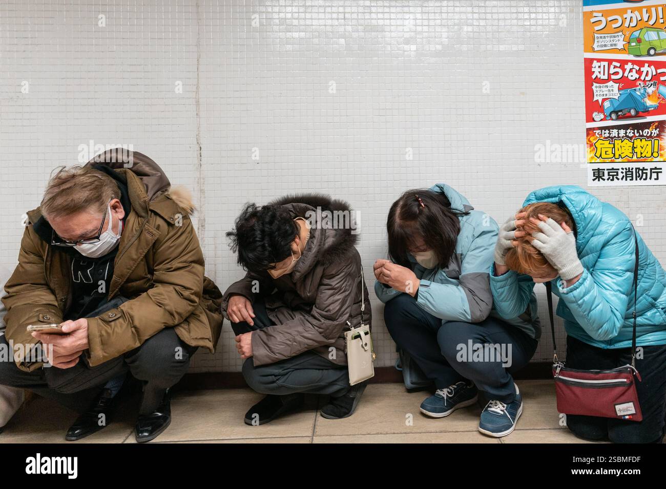 Tokyo, Japan. 4th Feb, 2025. Volunteers protect their heads during a ...
