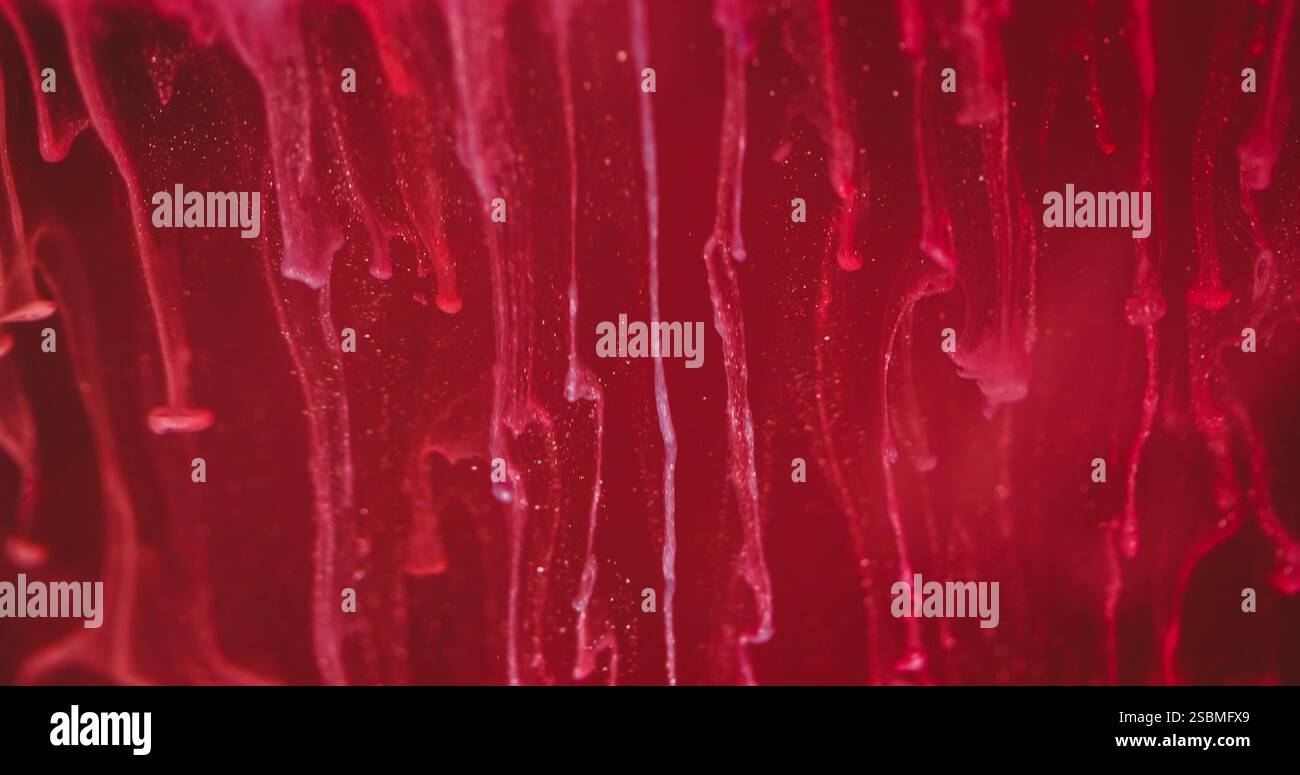 Abstract leaking paint. Blur flow pour. Defocused red color shine ...