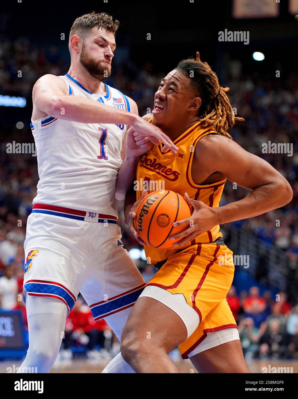 Kansas center Hunter Dickinson, left, tries to steal the ball from Iowa ...