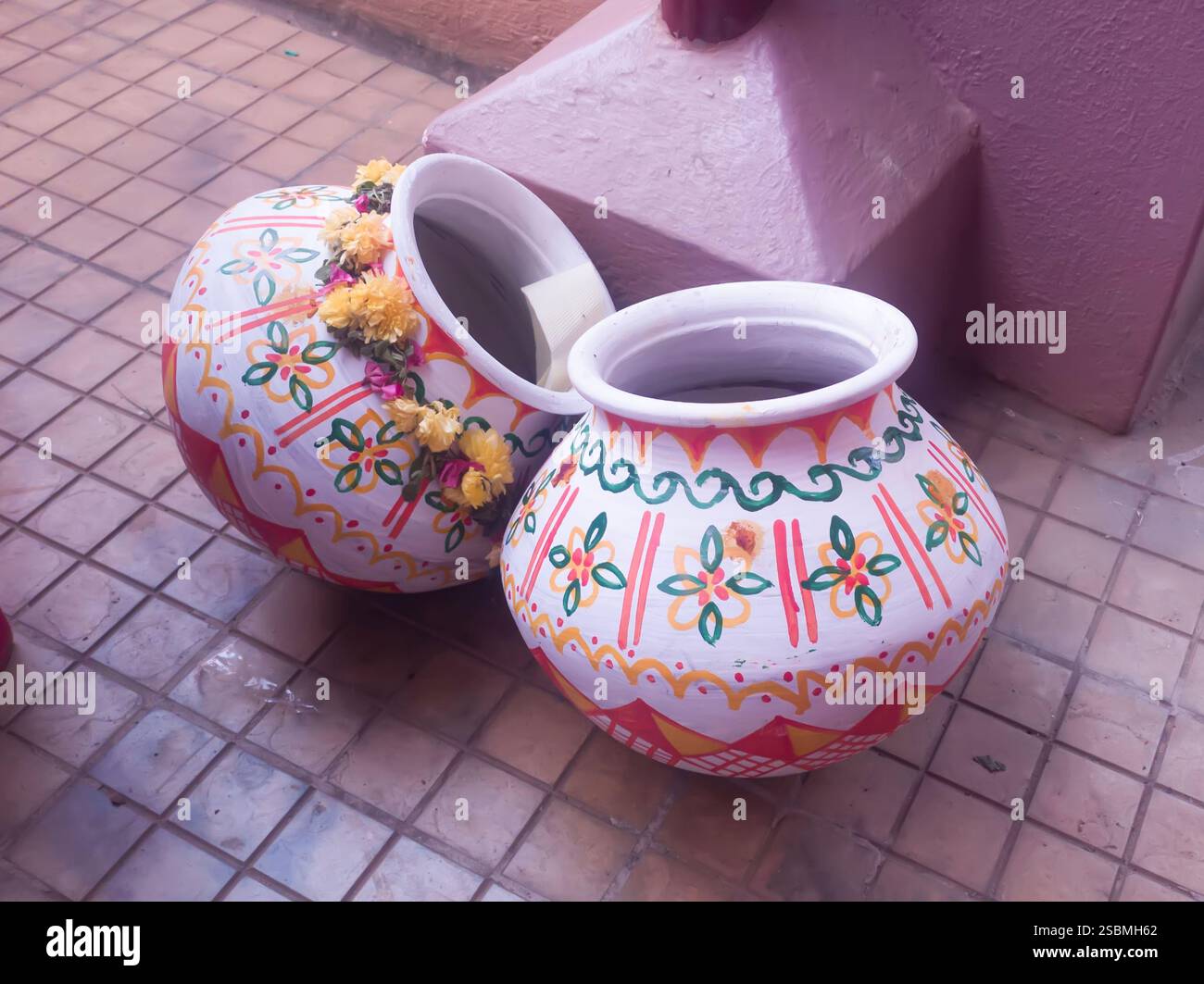 Brightly decorated handcrafted clay pots with colorful floral patterns ...