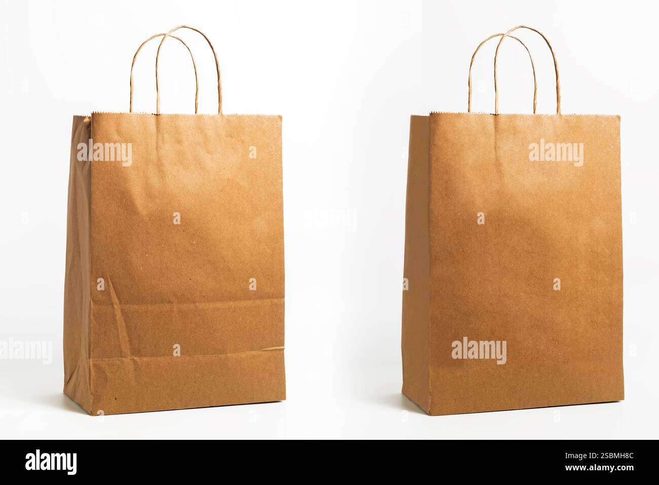 Brown paper bags with handles on a white background, showing the ...