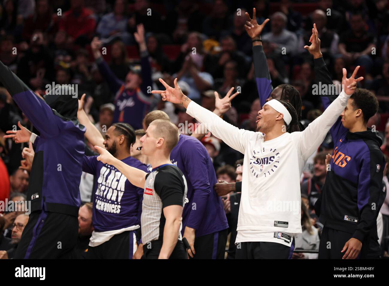The Phoenix Suns bench reacts as guard Devin Booker (not shown) becomes ...