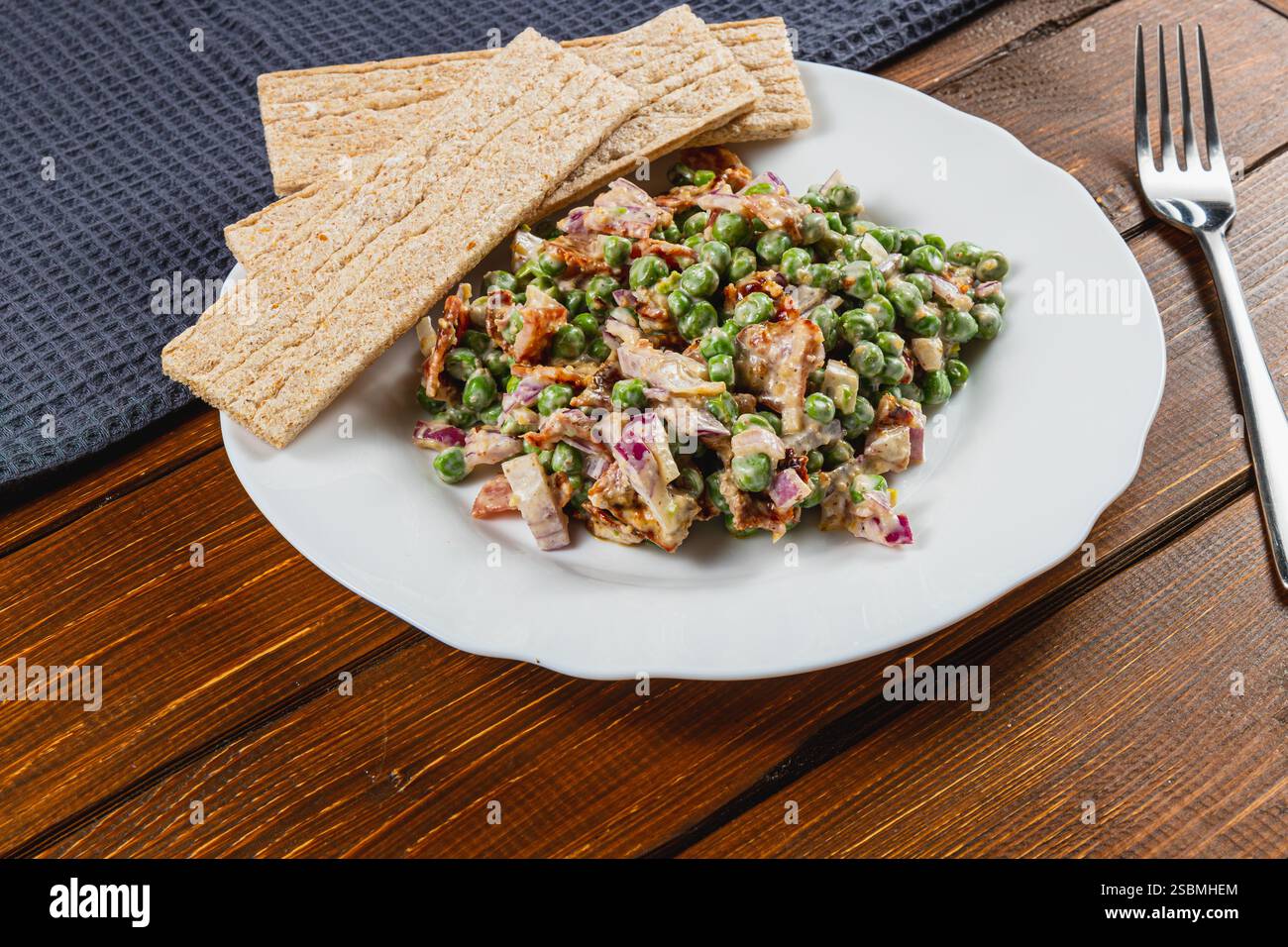 A vibrant salad features fresh green peas mixed with finely chopped ...