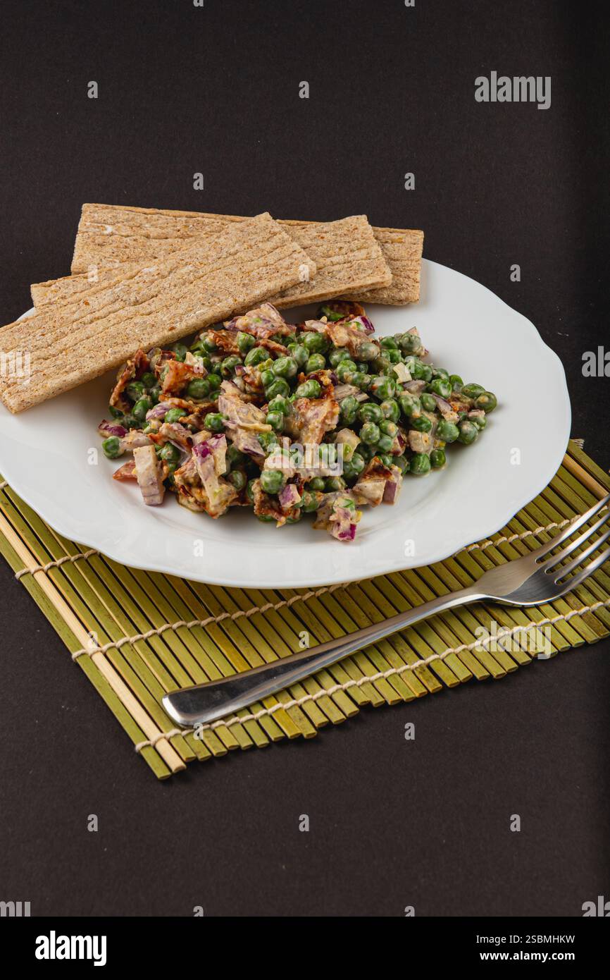 Vibrant green peas mixed with chopped scallions and purple onion create ...