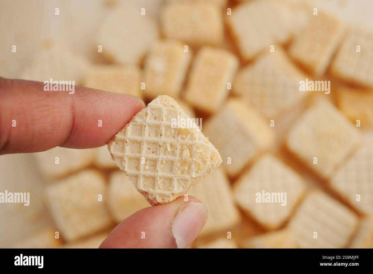 Hand with a crunchy wafer Stock Photo - Alamy