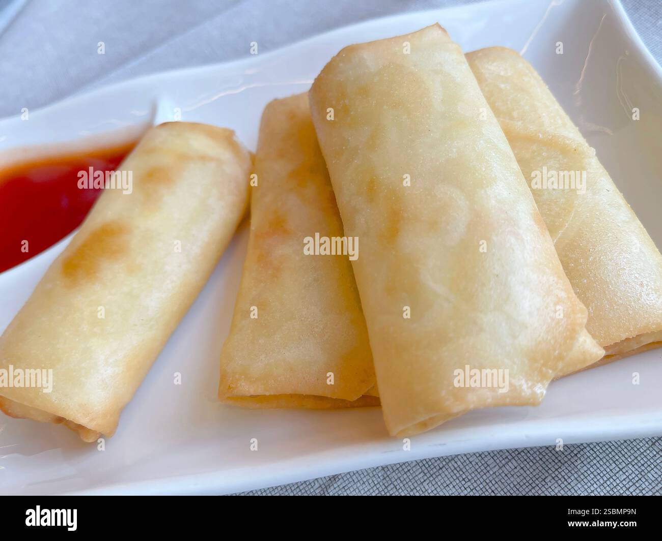 Vegetarian spring roll with cabbage on plate with sauce. Asian cuisine ...