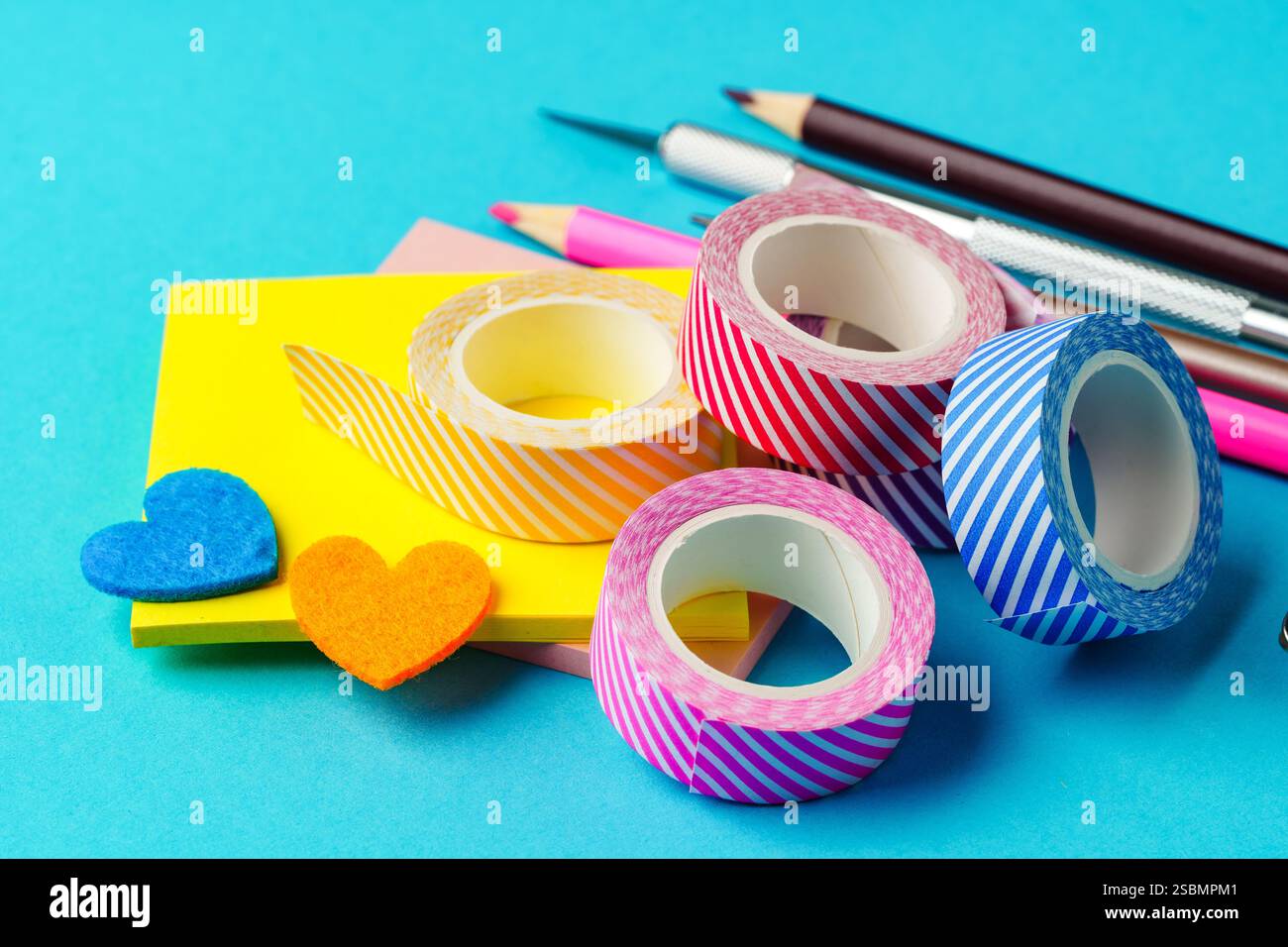 Colorful stationery items arranged on a bright blue background for ...