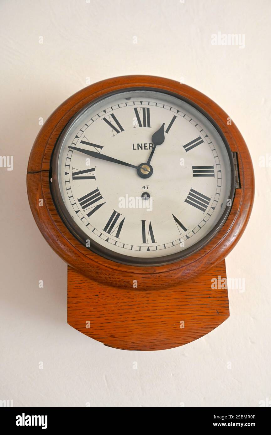 Vintage wooden round clock LNER with Rome numbers on white background ...