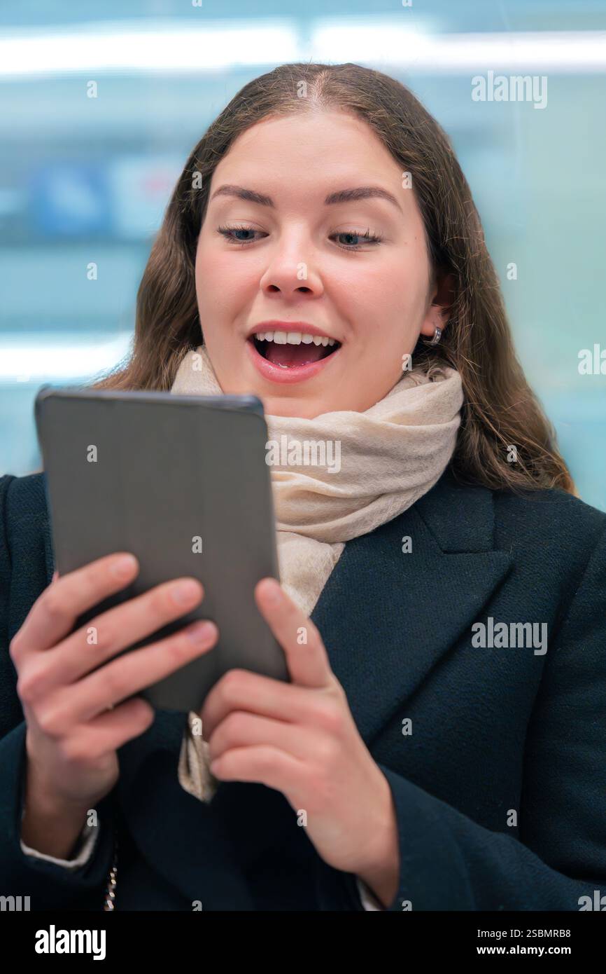 Smiling Young Woman Reading on E-Reader While Commuting on Subway Train ...