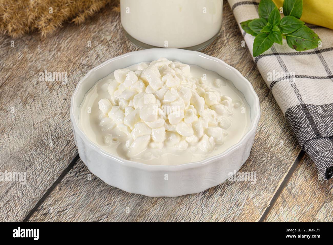 Grain cottage cheese with sour in the bowl Stock Photo - Alamy
