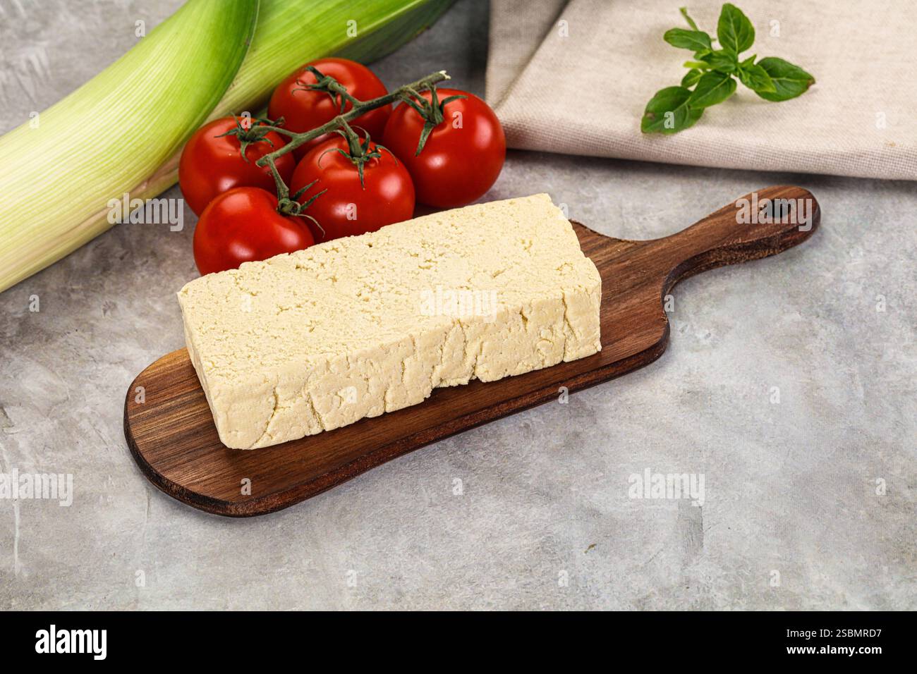 Soya vegan tofu cheese brick over board Stock Photo - Alamy