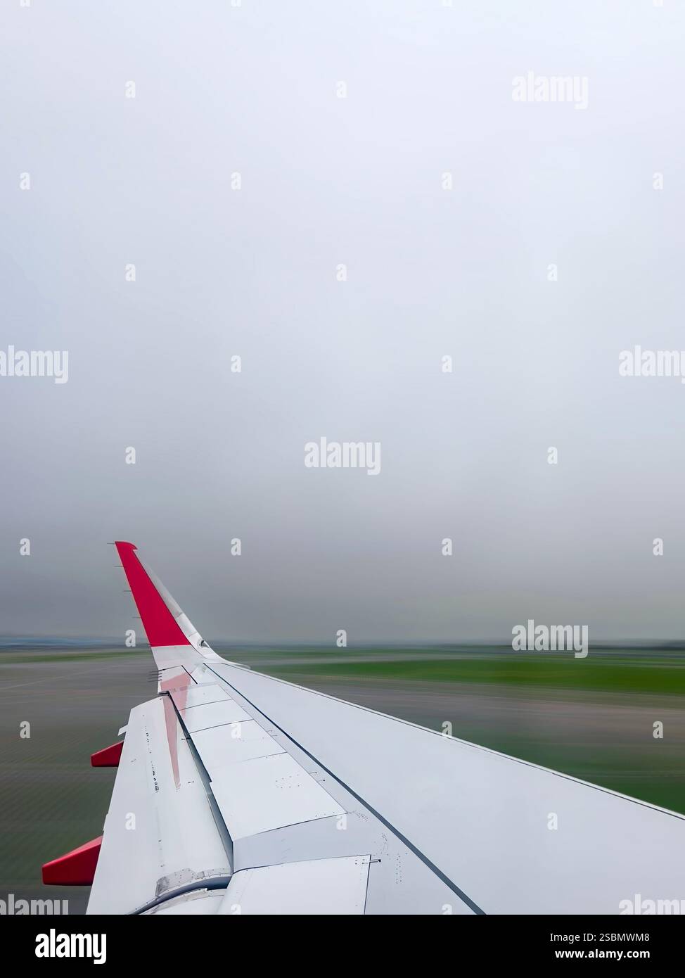View of an airplane wing on the runway during landing or take off ...