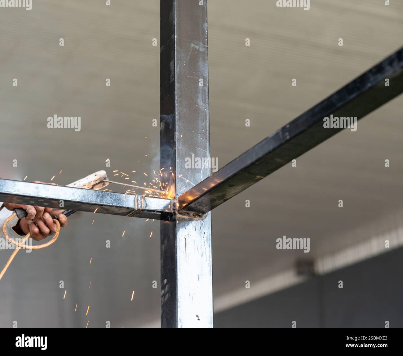 Worker welding structure in factory Stock Photo - Alamy