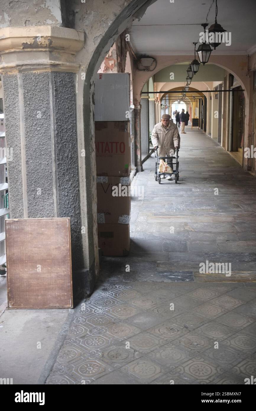 Busseto, Parma, Italy - January 31st 2025 Elderly man walking with a ...