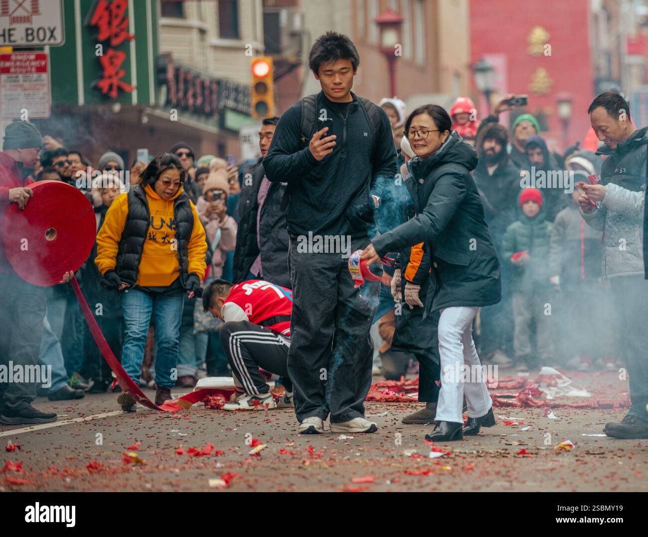 Spectators watch firecrackers explode at the Lunar New Year Parade 2025 ...