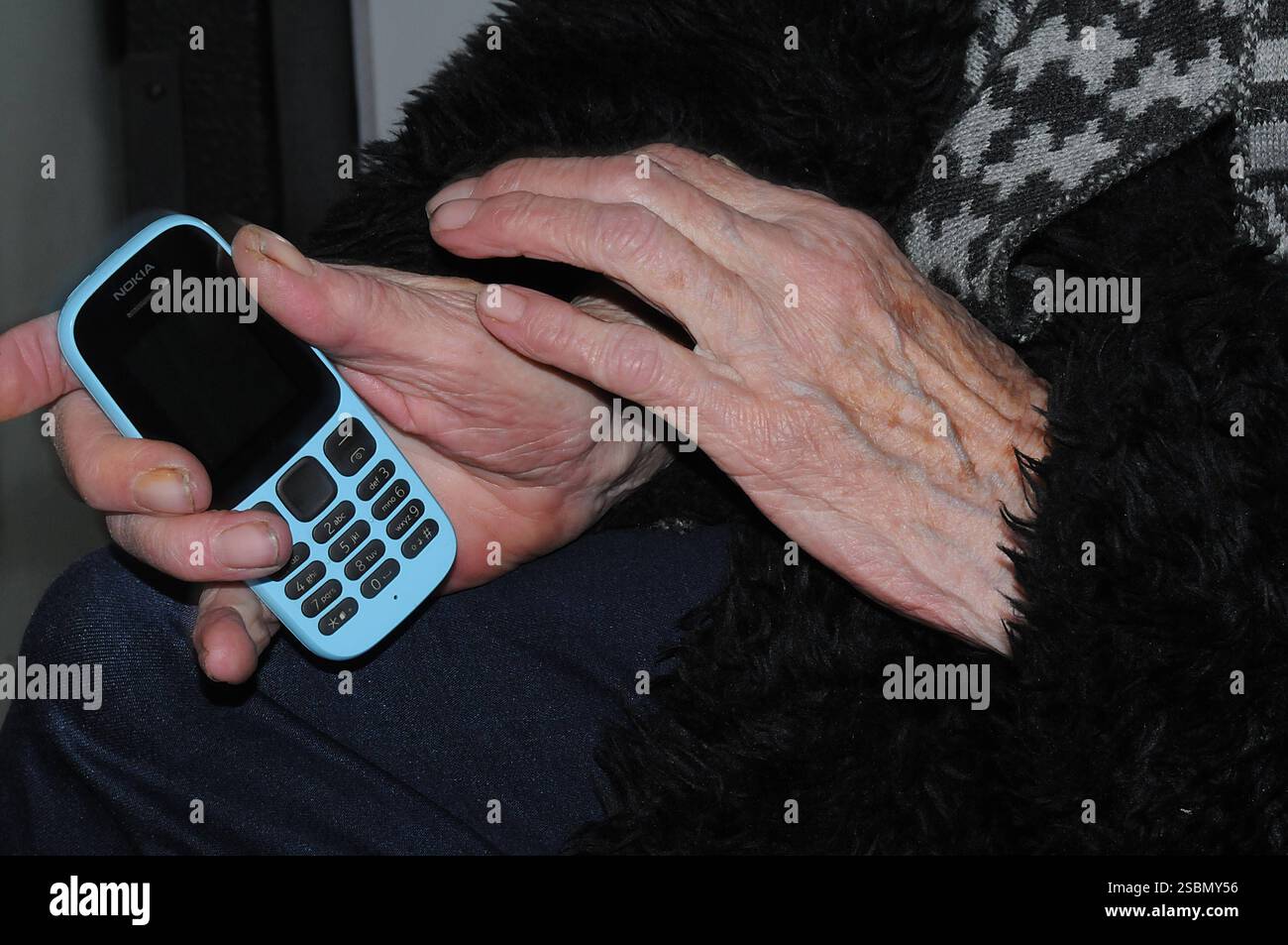 Copenhagen, Denmark. 15 March 2021, Senior citizen with old nokia model ...