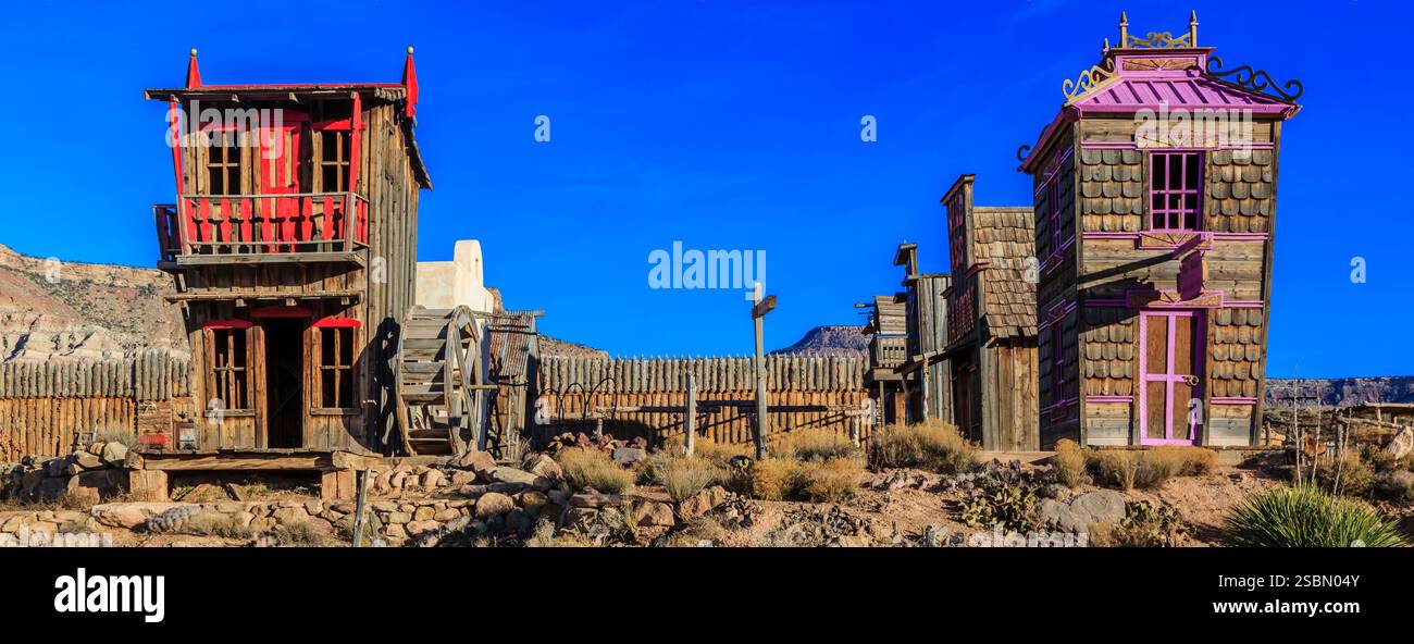 House with a red door is next to another house. The houses are in a ...