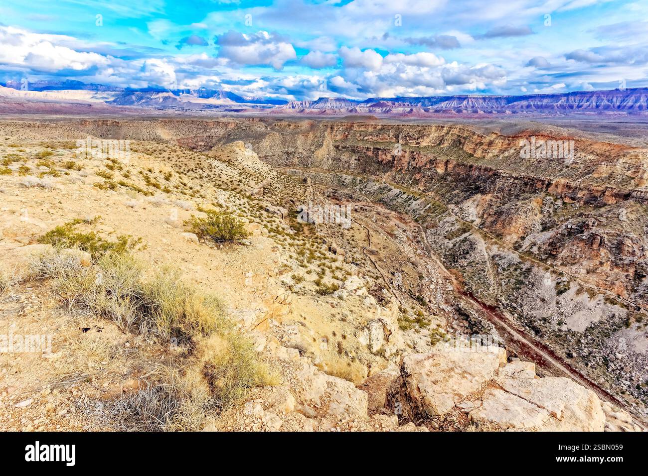 Mountain range with a valley in between. The valley is rocky and barren ...