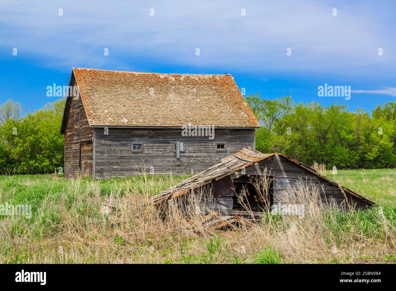 Large, old, wooden building with a slanted roof. The roof is covered in ...