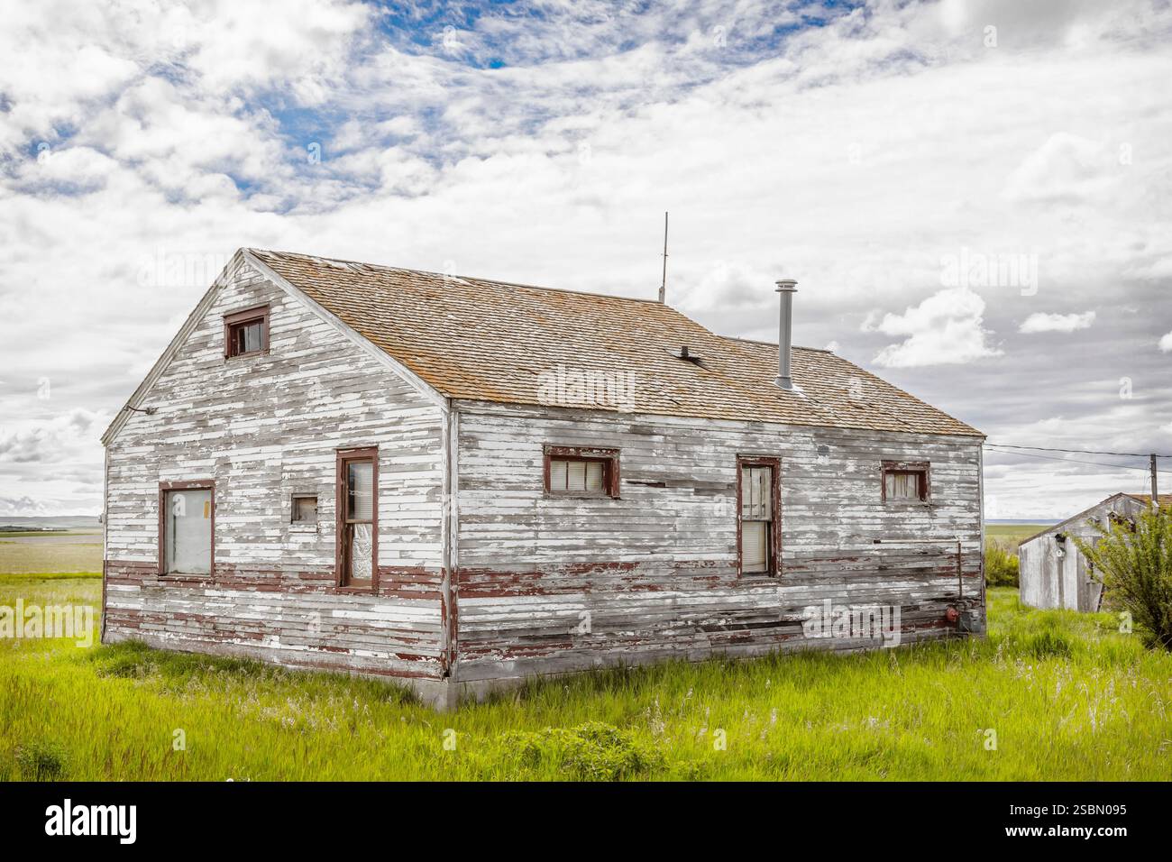 Small, old house with a chimney and a roof. The roof is made of ...
