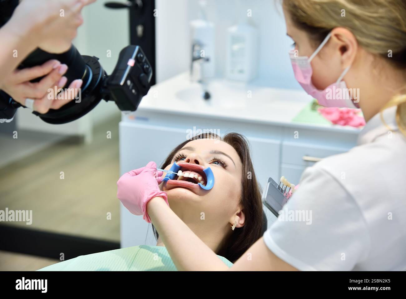 Dentist woman photographing teeth before teeth whitening procedure ...