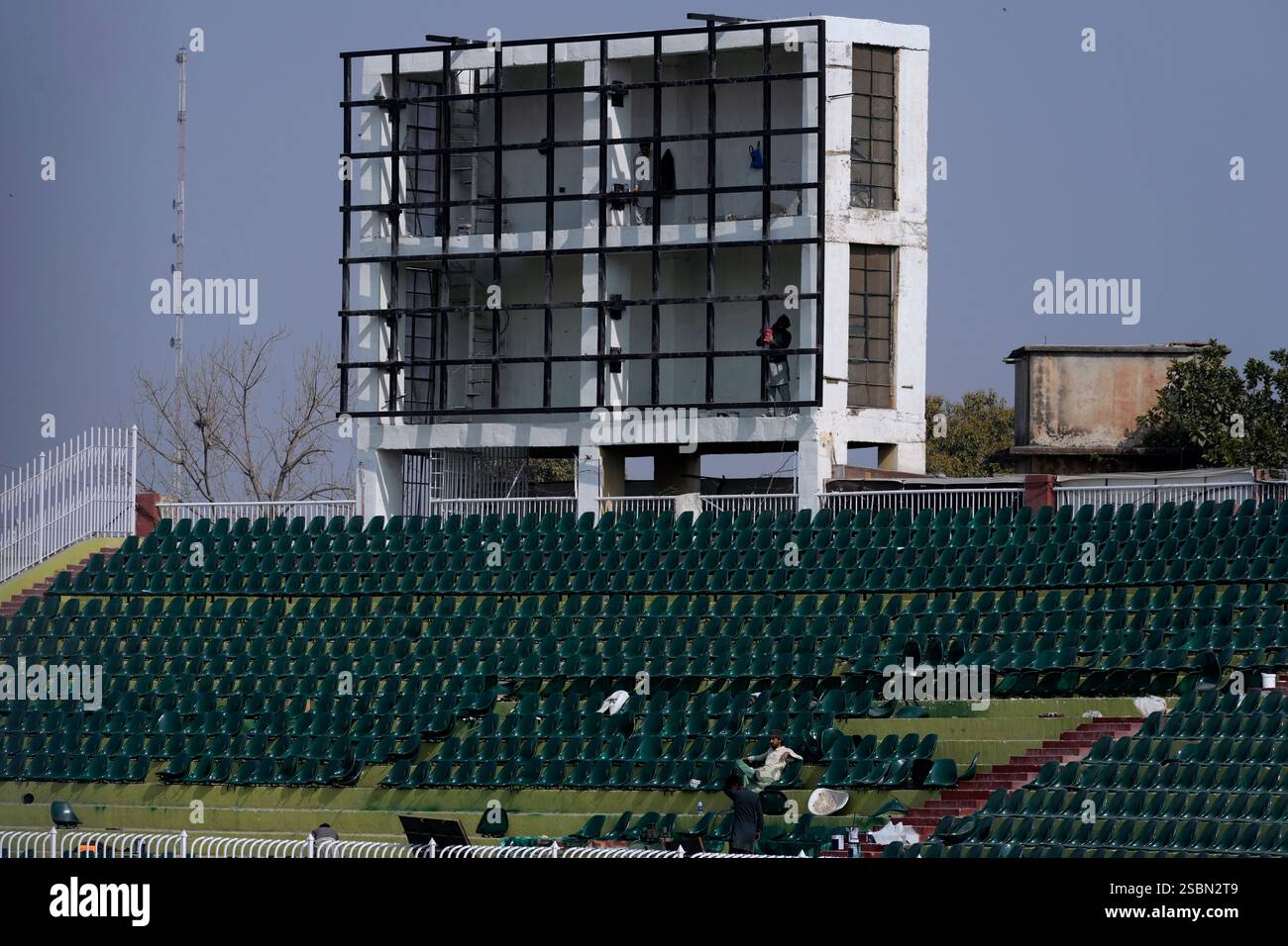 Laborers work to install new scoreboard at the Pindi Cricket Stadium ...