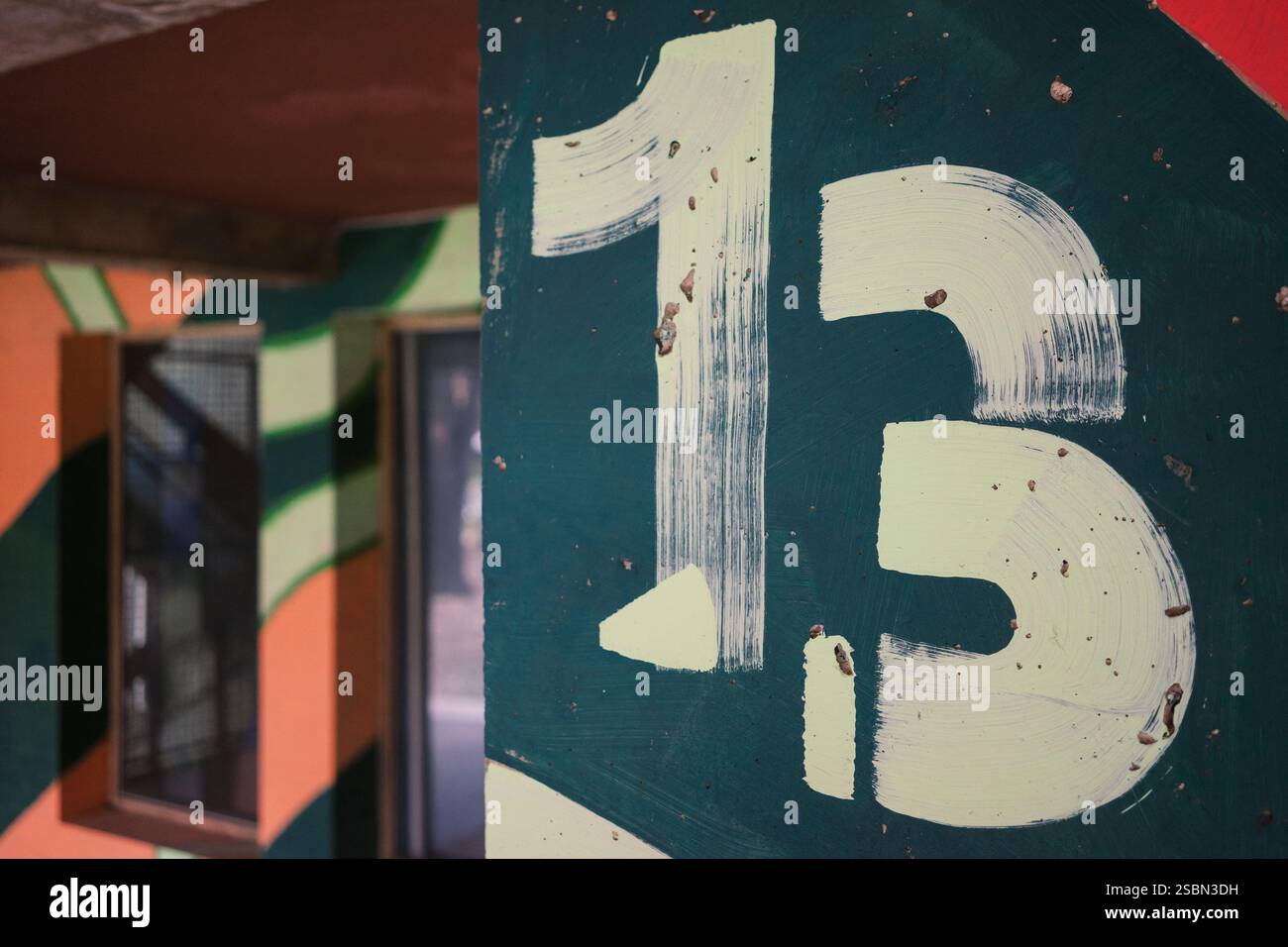 Painted walls at the entrance to the building with the number thirteen ...